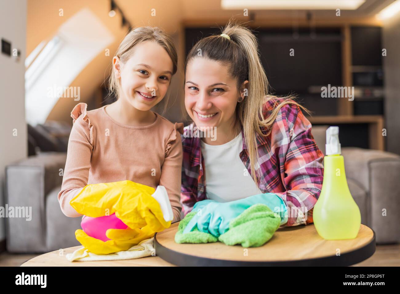 Happy daughter and mother cleaning house together Stock Photo - Alamy
