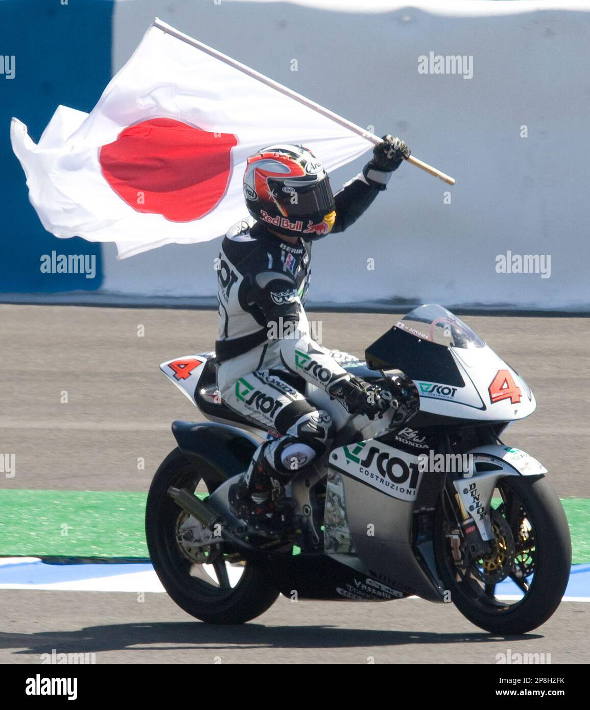 Japan's Aoyama Hiroshi celebrates with a Japanese flag after winning ...