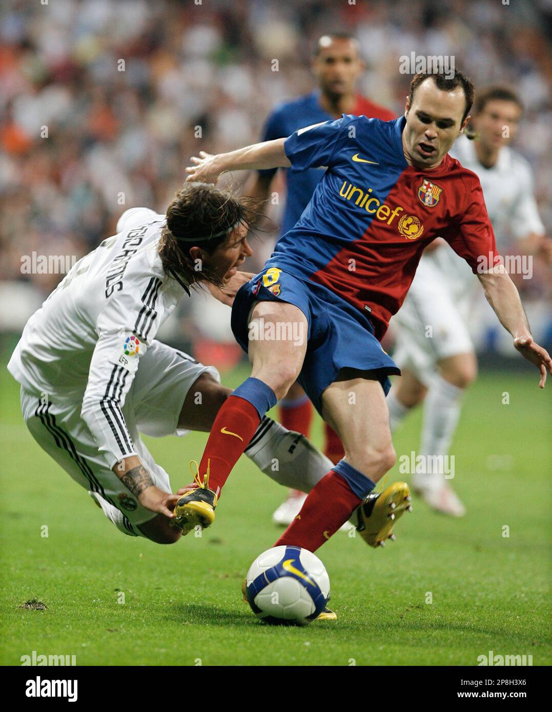 Real Madrid's Sergio Ramos from Spain duels for the ball with Barcelona ...