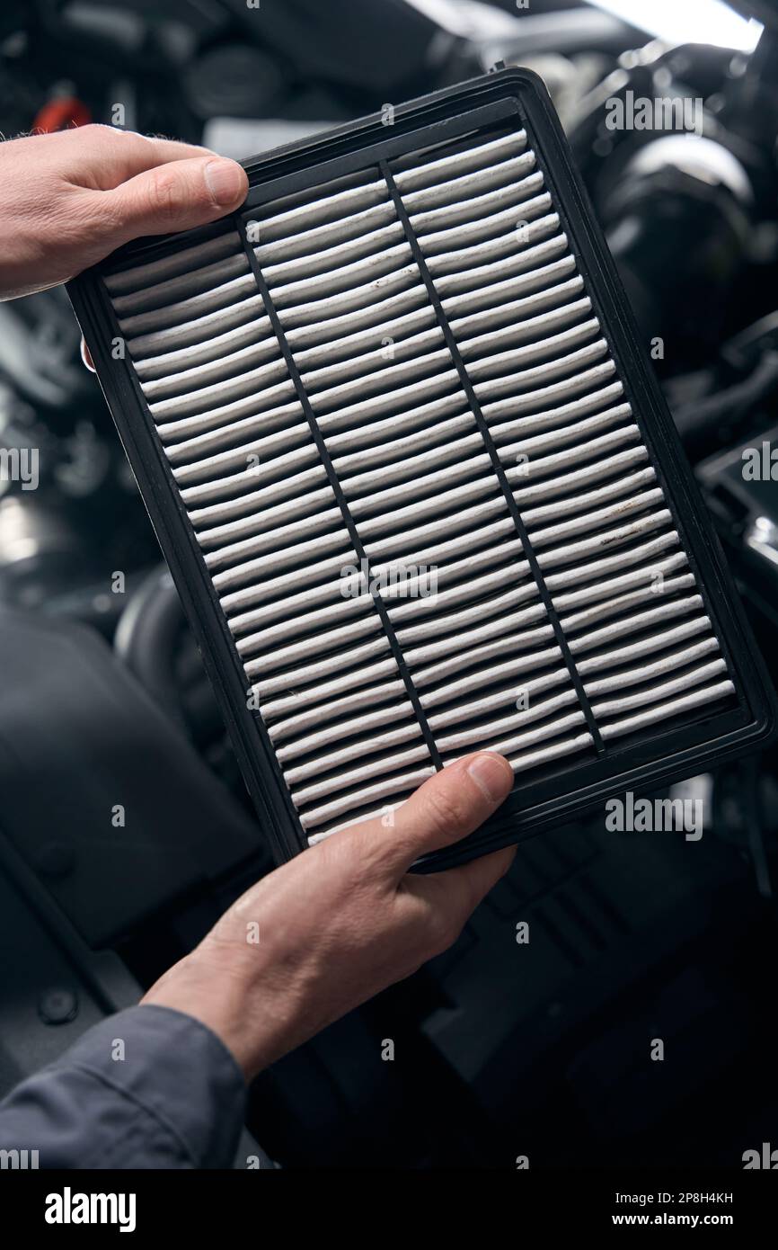 Man changing spare parts in the car Stock Photo - Alamy