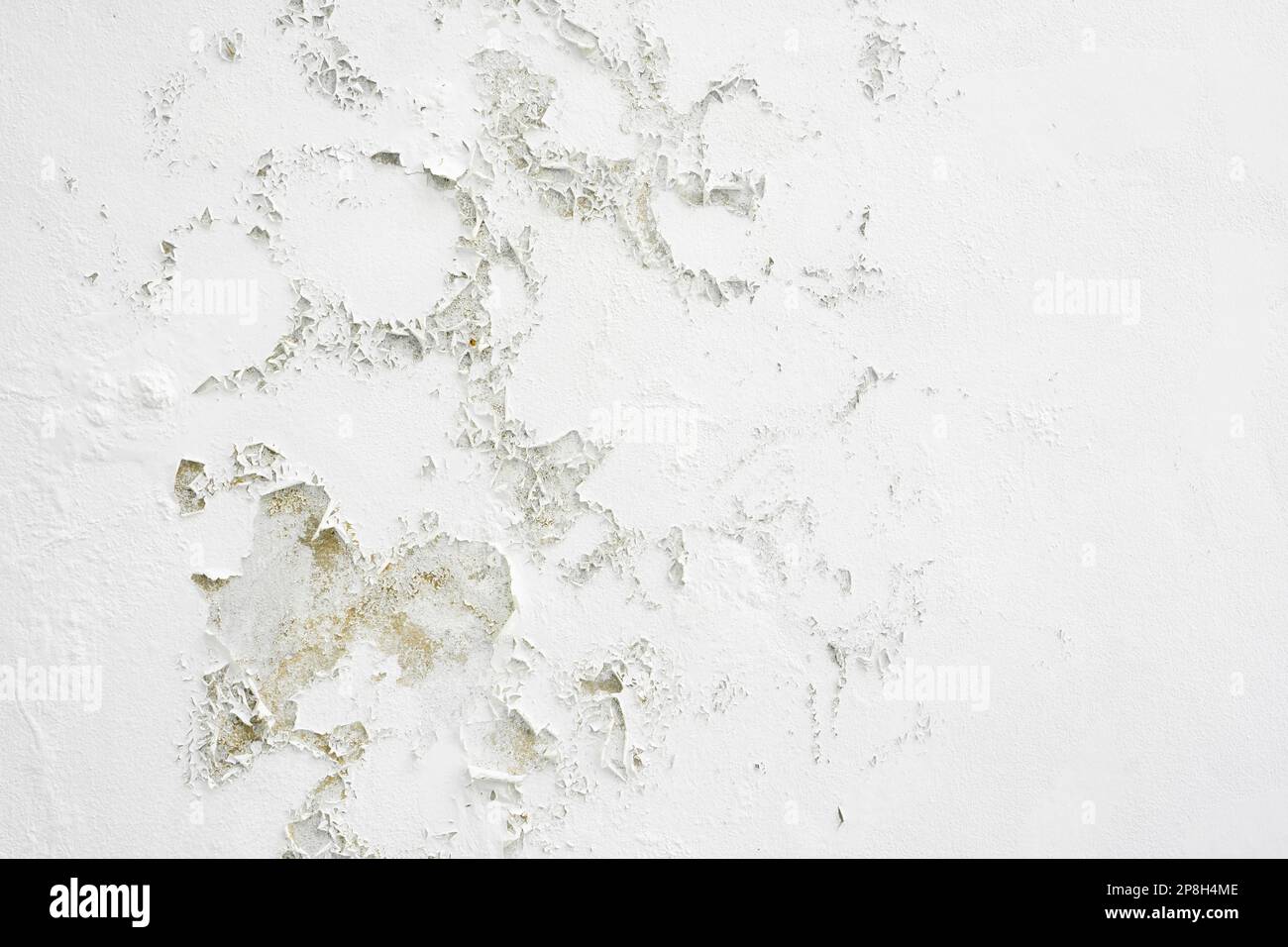 The badly fixed building facade wall covered with cracks in stucco and ...