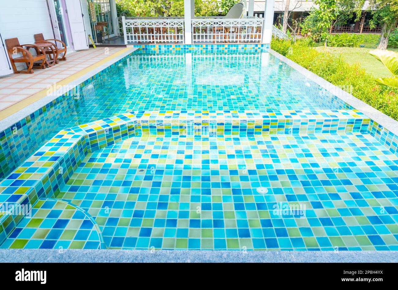 Macro from Swimming pool with clear blue water in a garden area ...