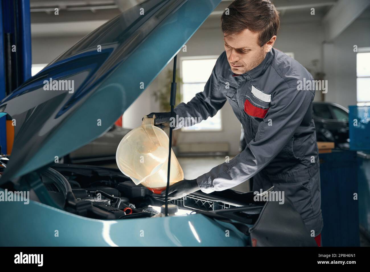 Man conducts full technical inspection of car Stock Photo - Alamy