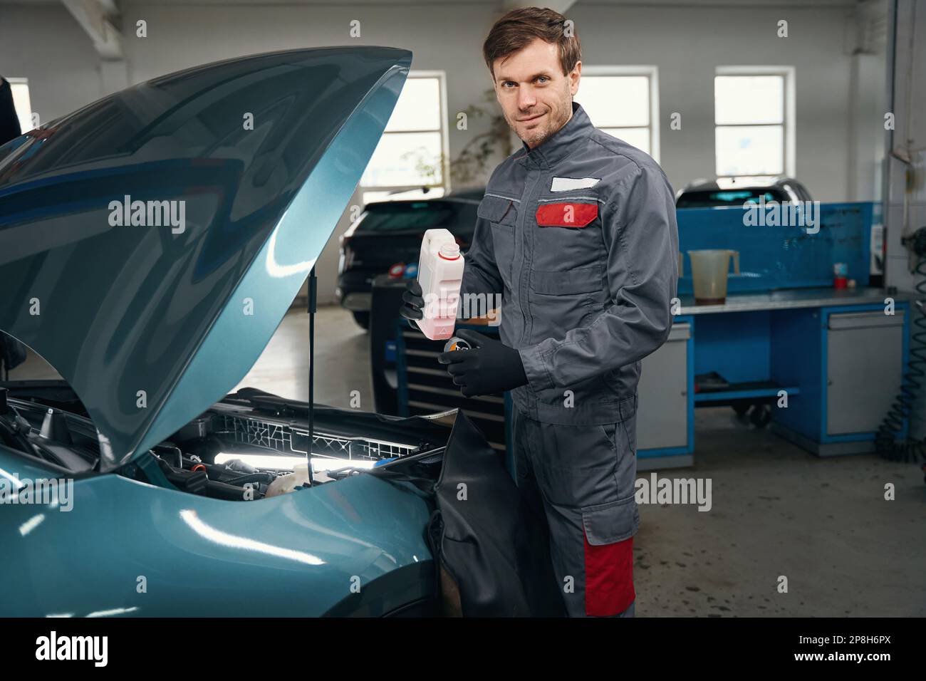 Male conducts full technical inspection of car Stock Photo - Alamy