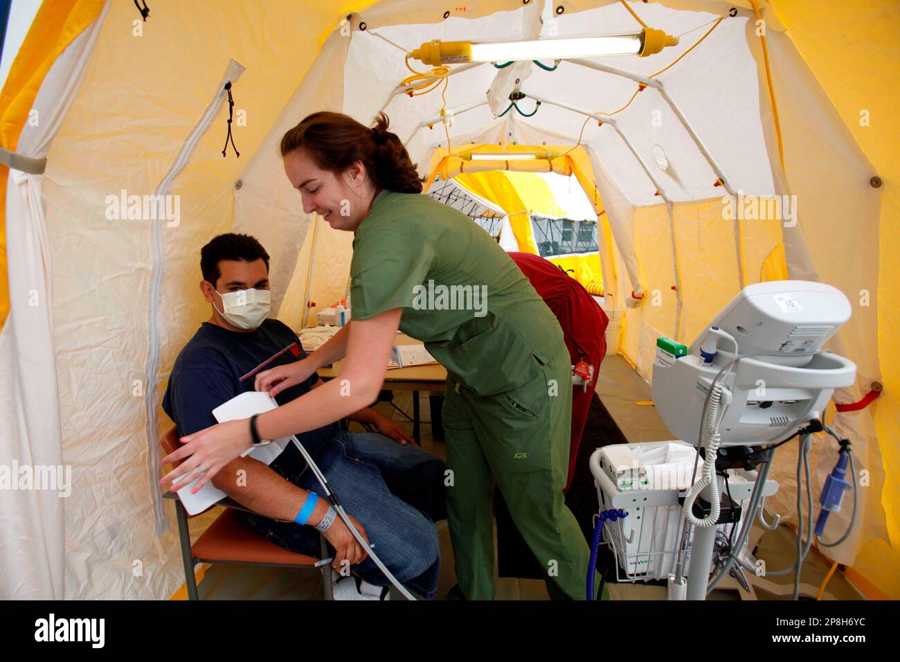 Nurse Torrey Jones takes a blood pressure cuff off of patient Art ...