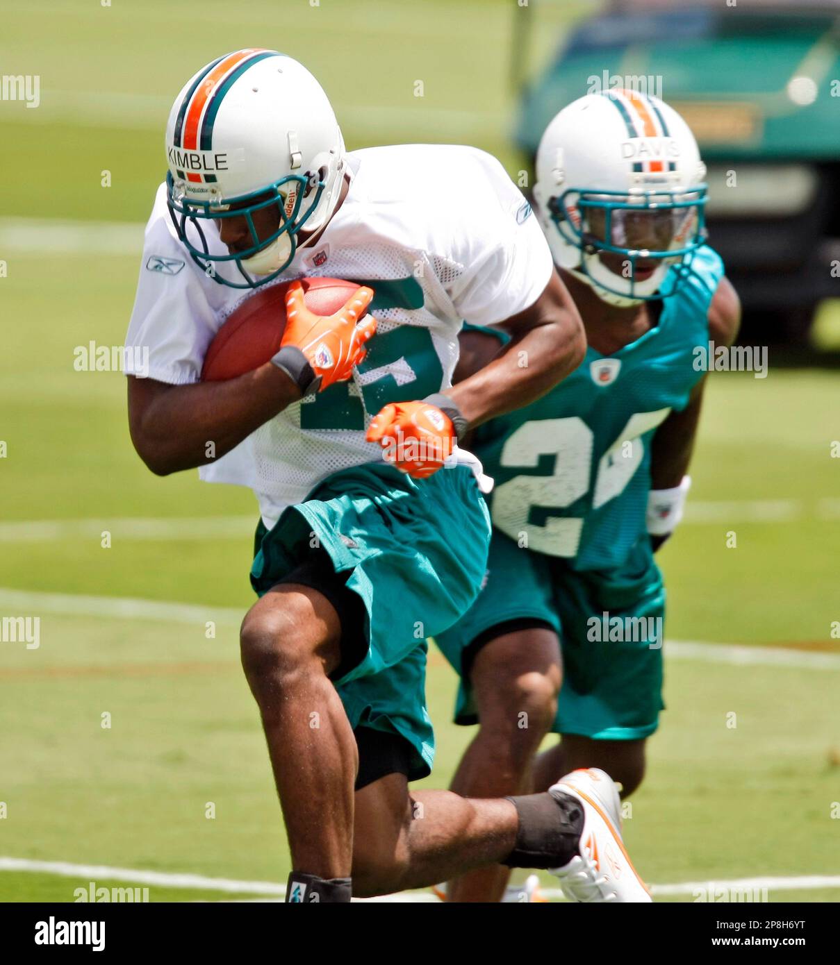 Miami Dolphins player Anthony Kimble (45) runs past Vontae Davis (24 ...