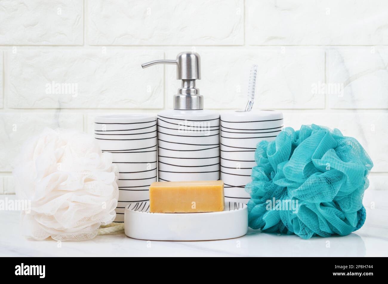 Herb soap, shower sponge and shampoo pump bottle inside a bright ...