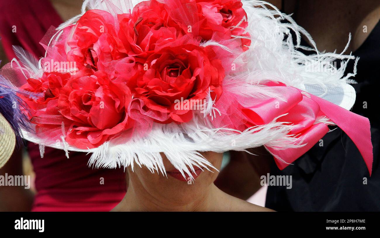 Victoria Moll of Louisville, Ky., wears a fancy hat while waiting for ...