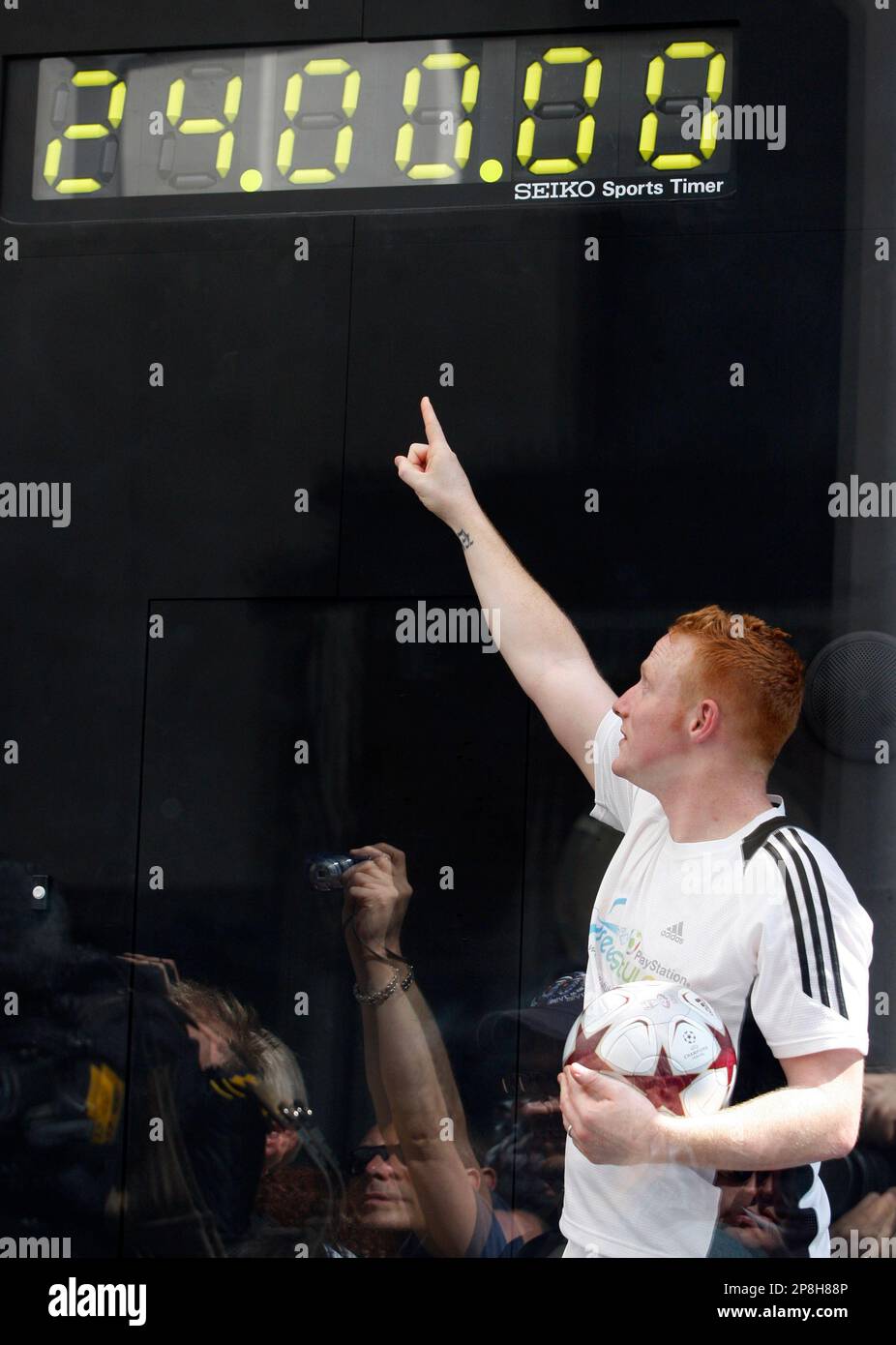 Football freestyler Dan Magness points to the clock as he celebrates ...