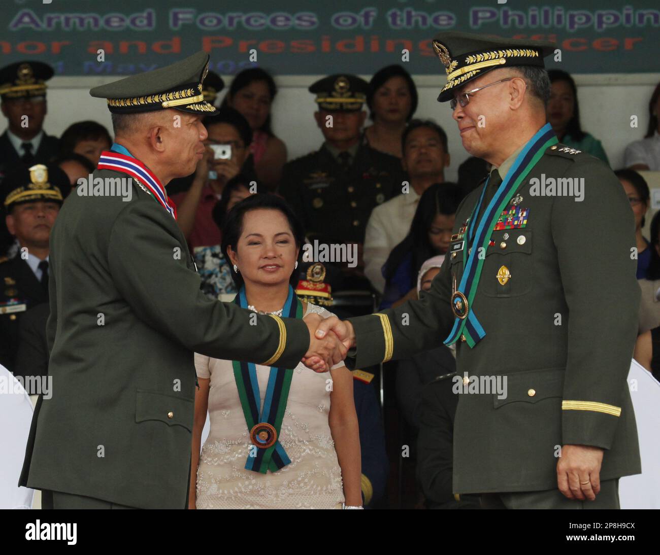 Philippine President Gloria Macapagal Arroyo, center, watches as ...