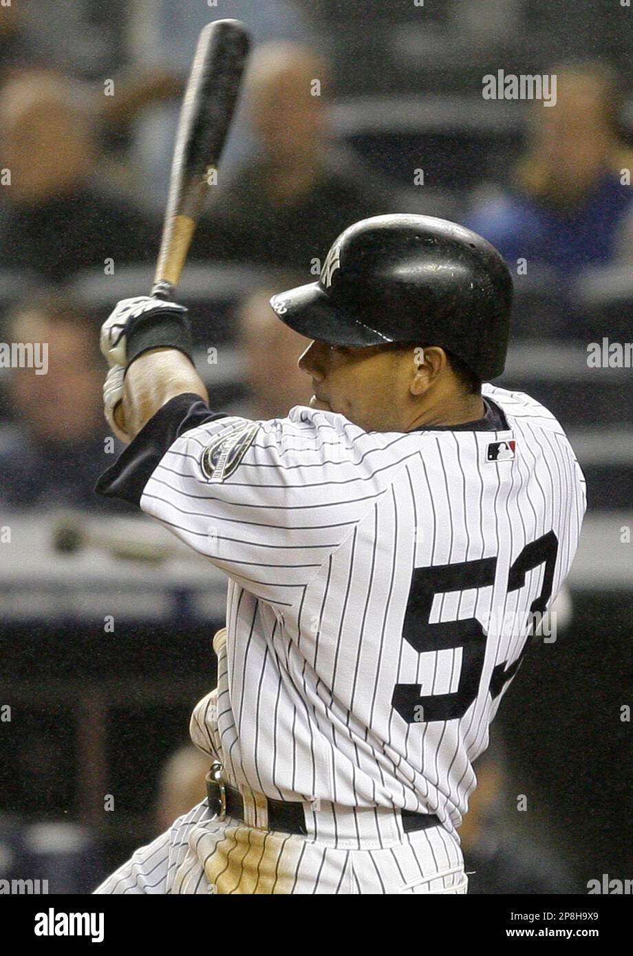 New York Yankees' Melky Cabrera follows through on an RBI single to ...
