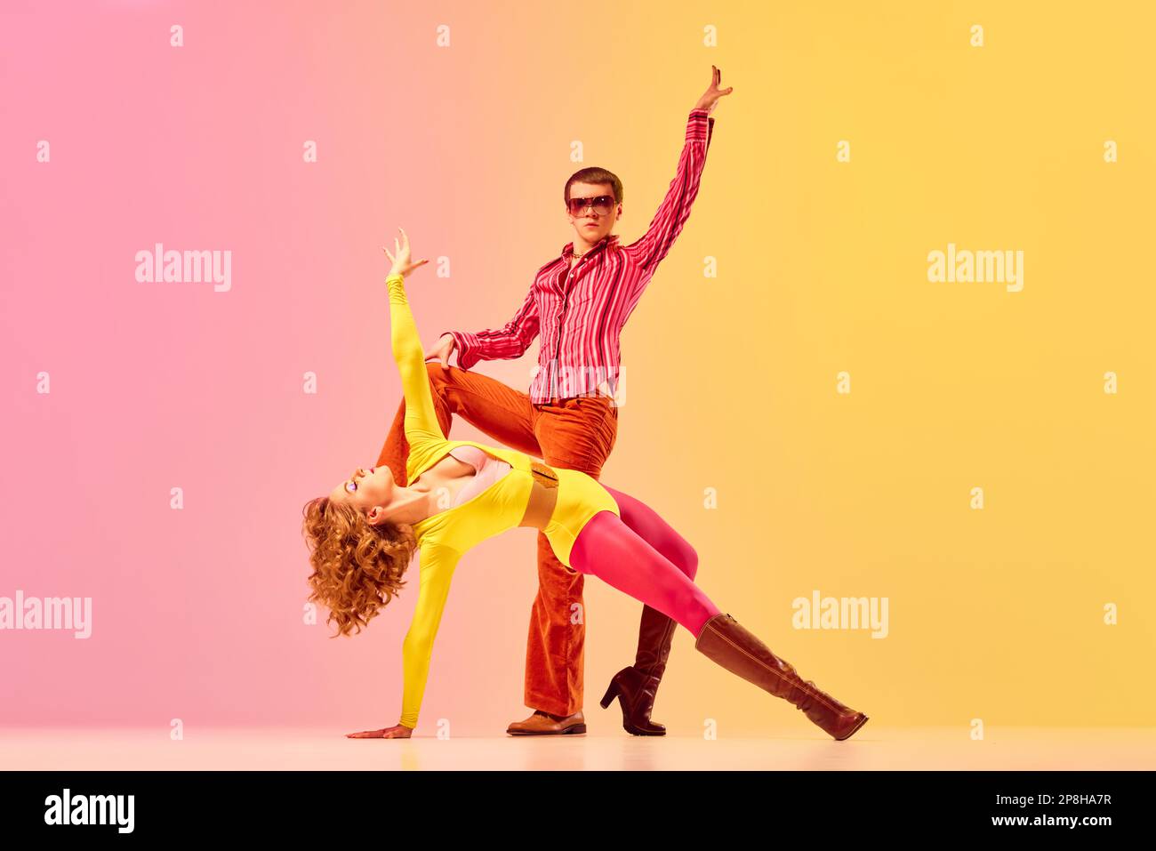 Young stylish emotional man and woman, professional dancers in retro ...