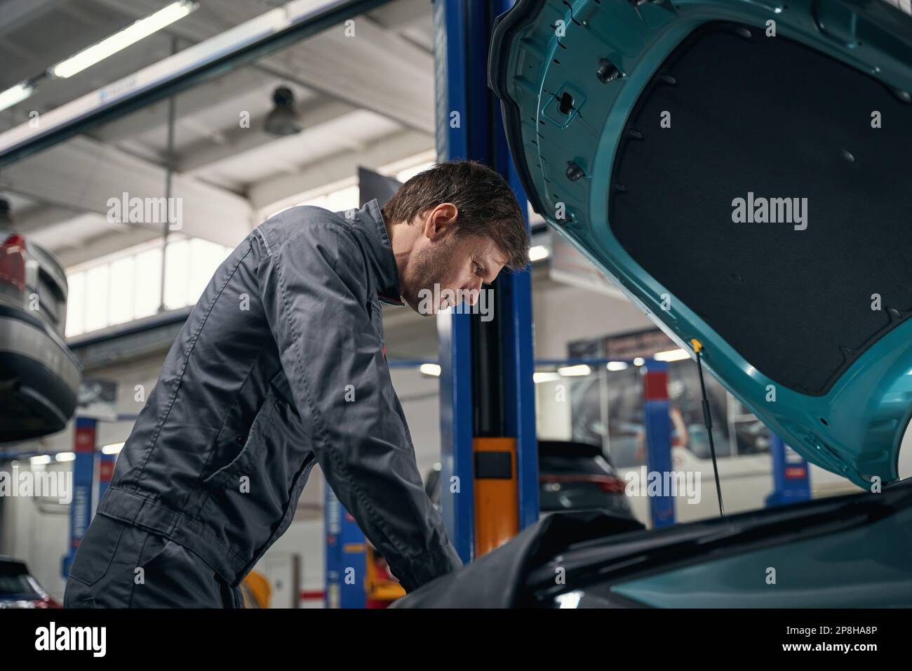 Male conducts full technical check of car Stock Photo - Alamy