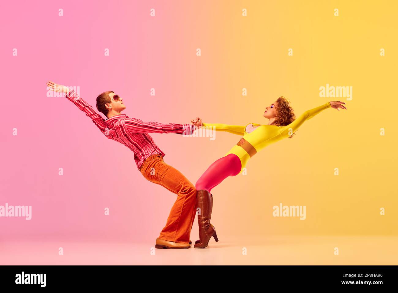 Young stylish emotional man and woman, professional dancers in retro ...