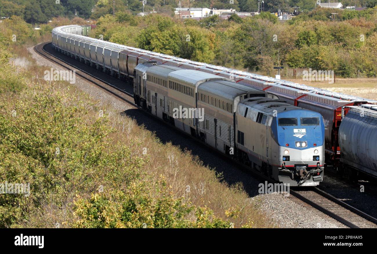 FILE -- In this Oct. 25, 2005 file photo, an Amtrak trains, front, passes by a freight train as ...