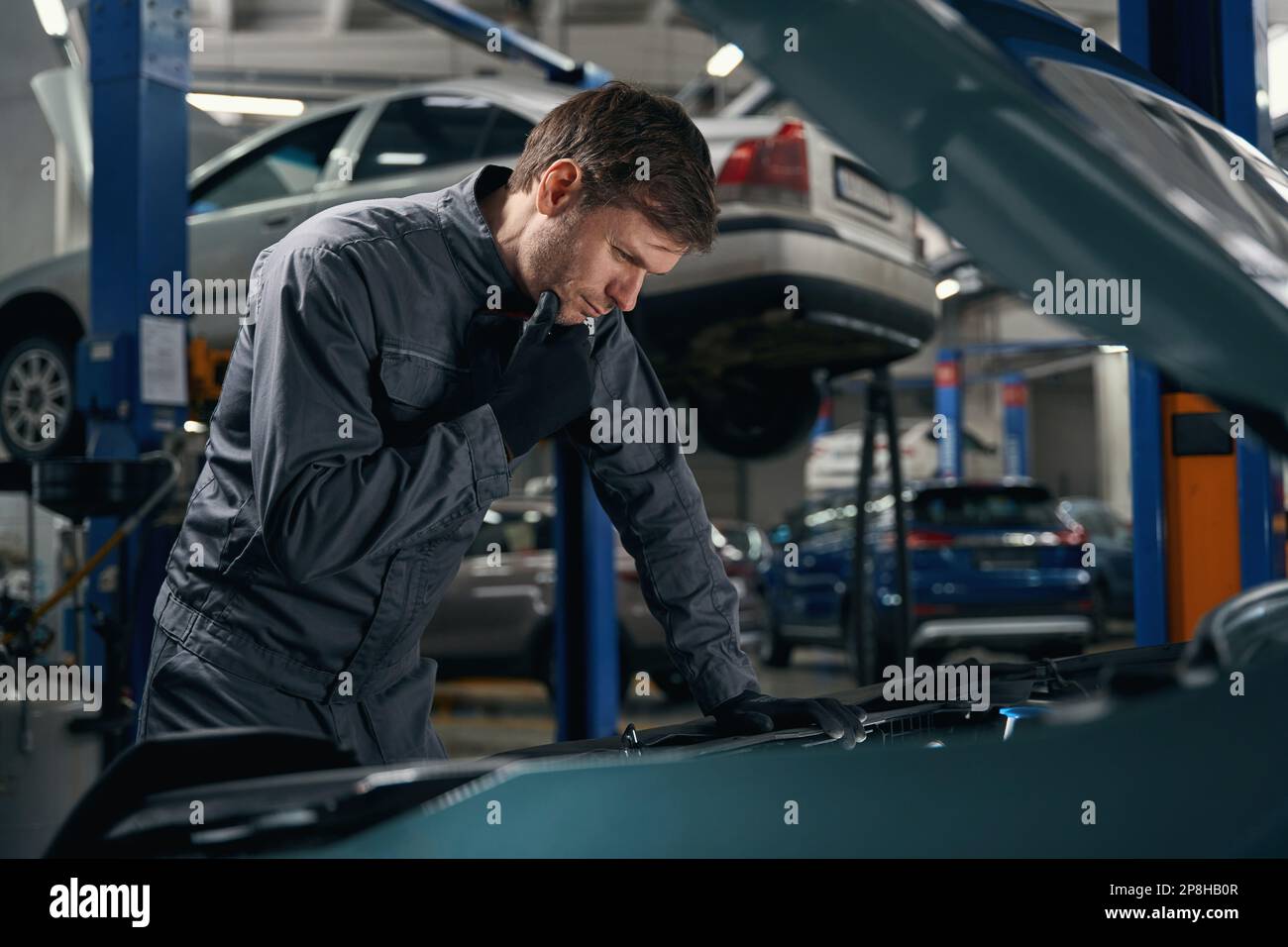 Male conducts full technical check of machine Stock Photo - Alamy