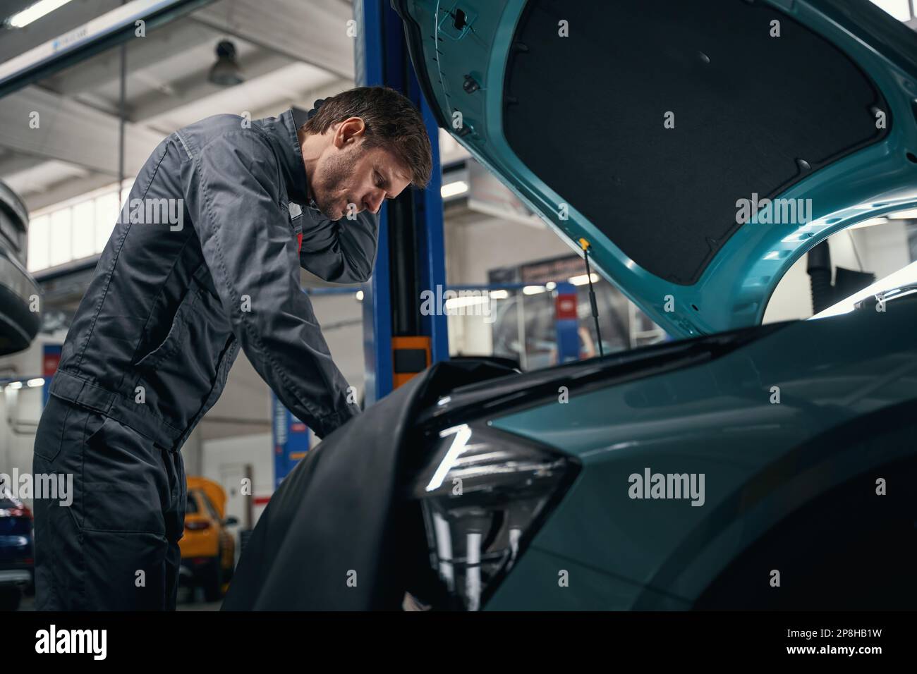 Mechanic conducts full technical check of machine Stock Photo - Alamy