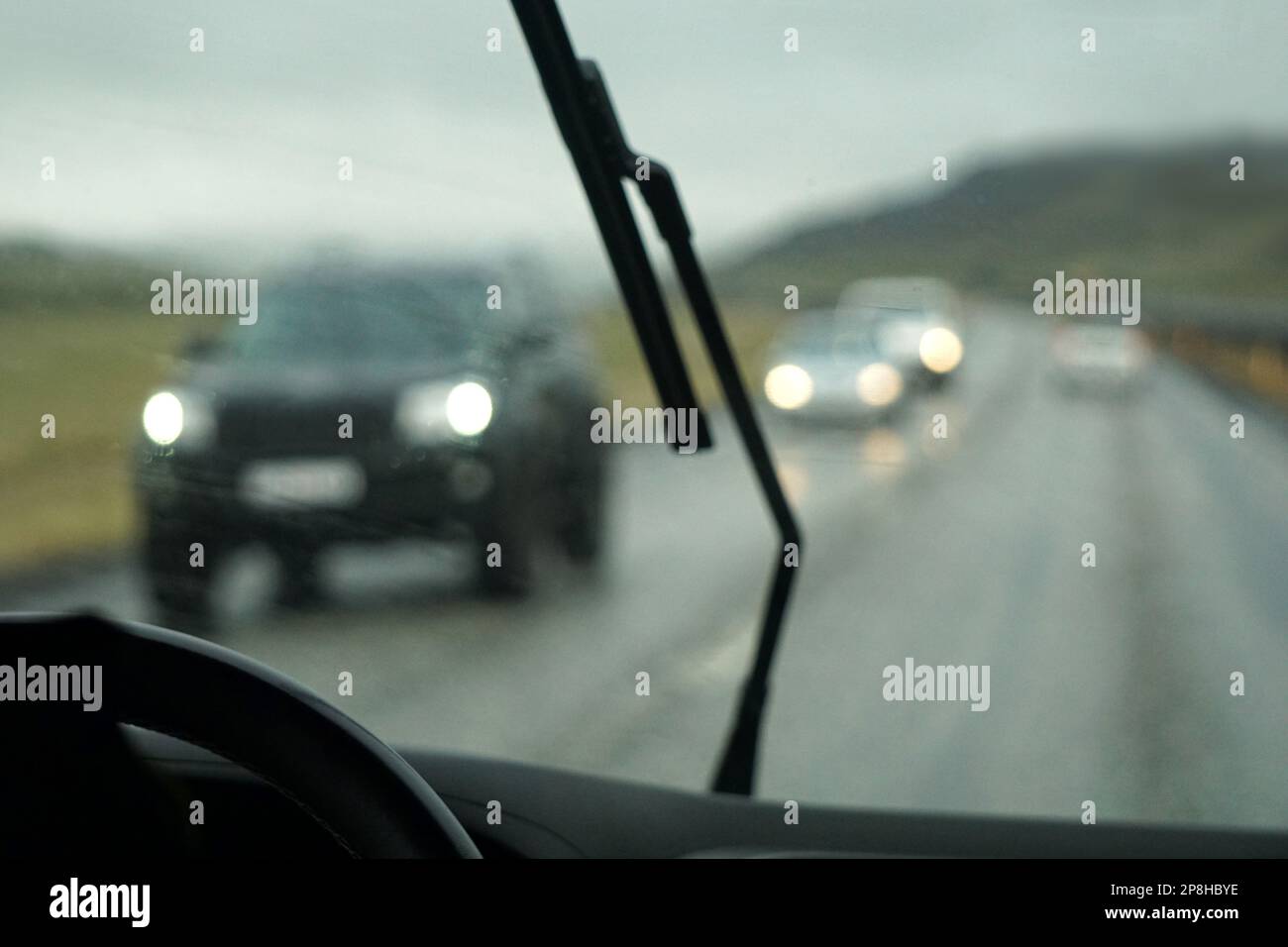 Driving a car in the rain with activated windshield wipers Stock Photo ...