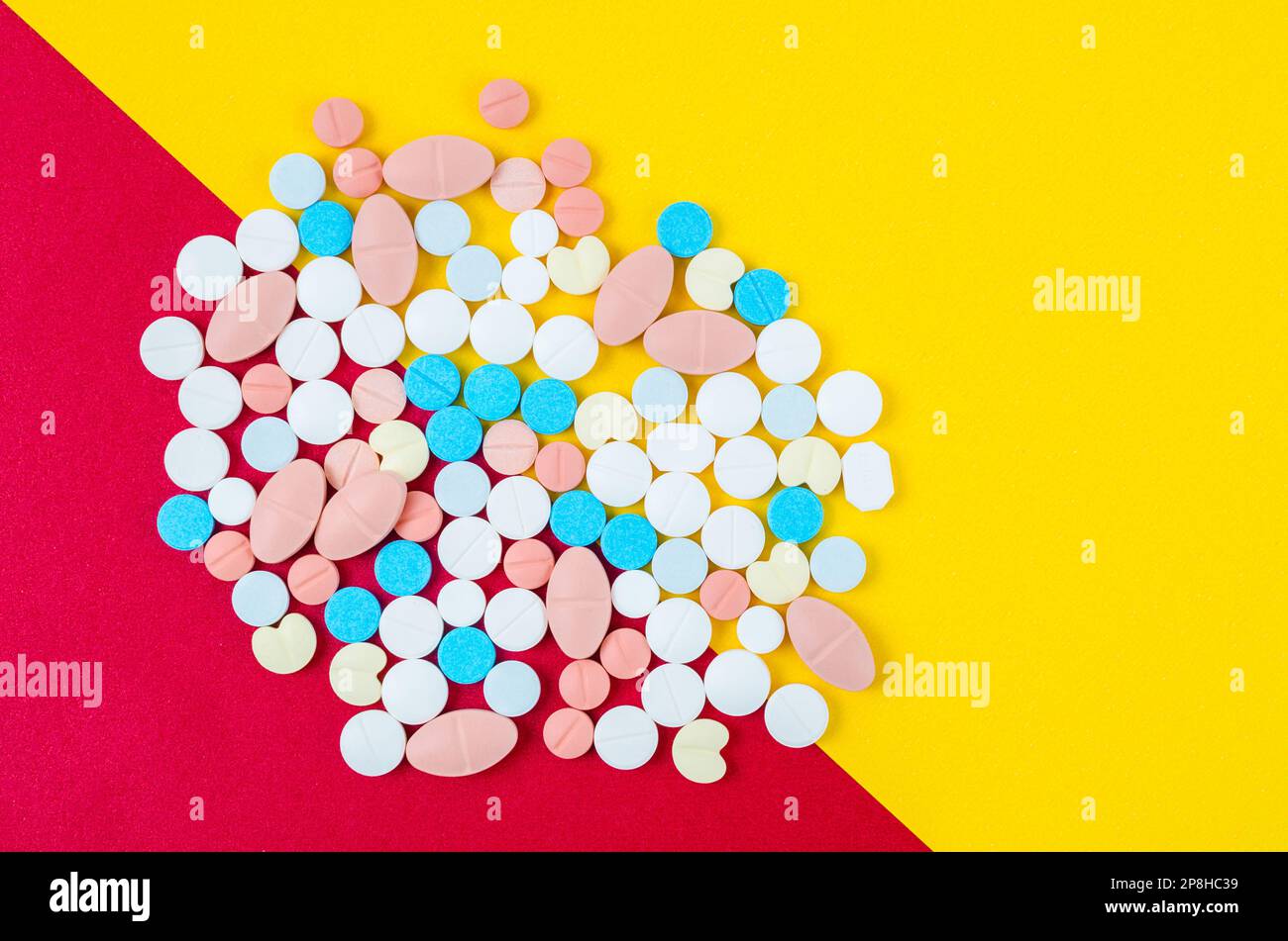 Colorful medicine tablets on yellow and red color background Stock ...