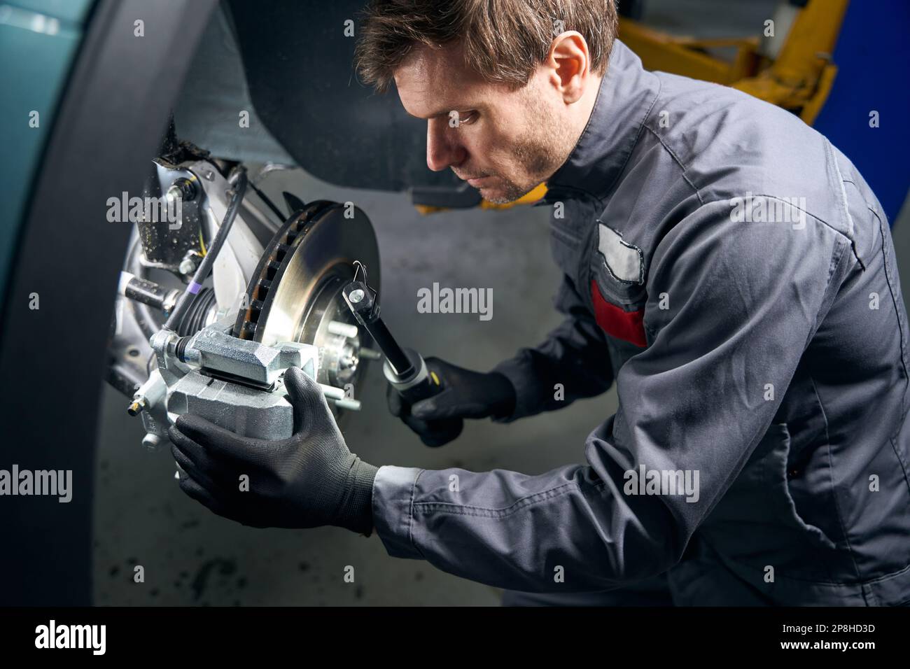 Mechanic doing inspection of the brake system Stock Photo - Alamy