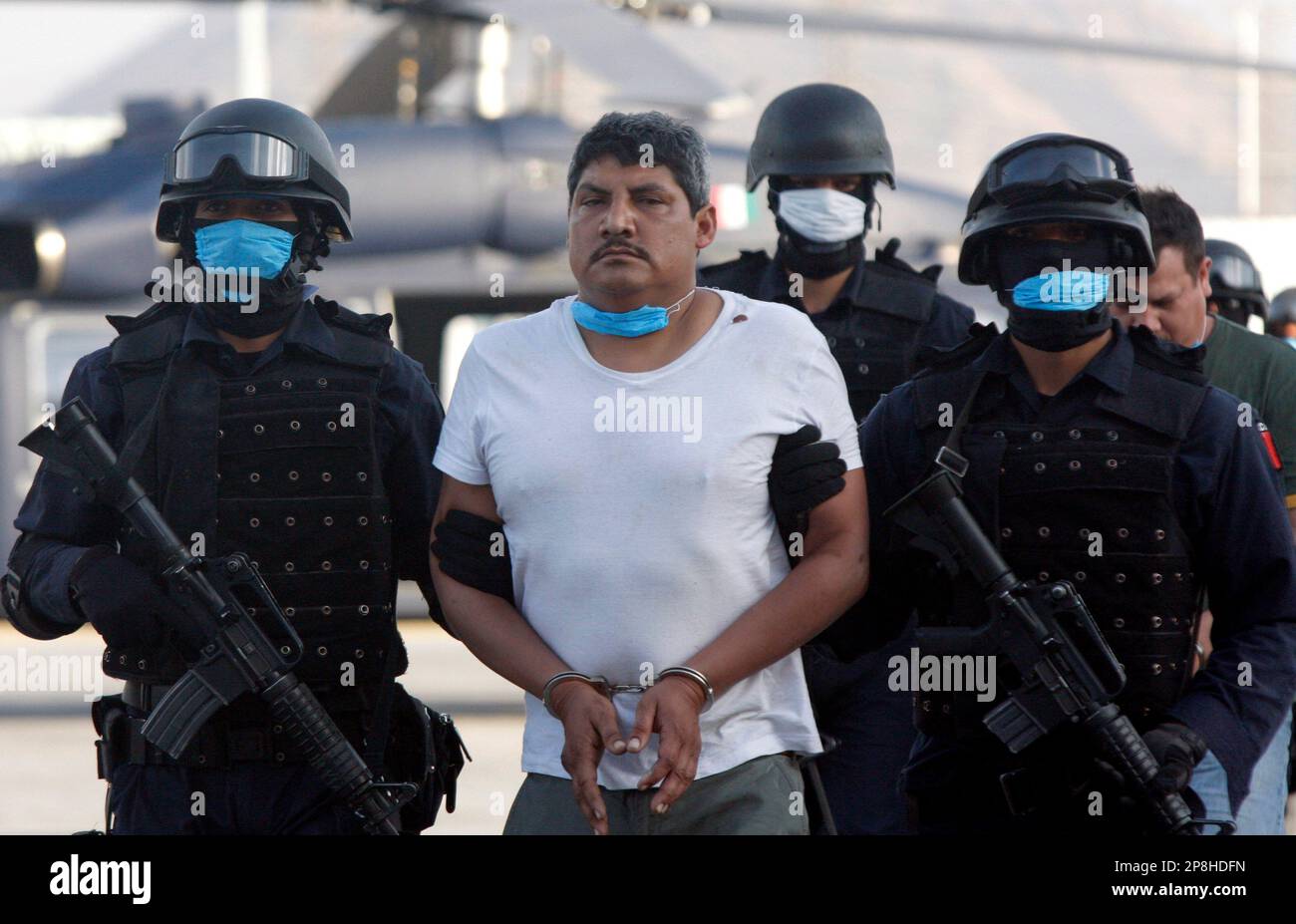Suspected member of the Gulf Cartel Gregorio Sauceda Gamboa is escorted ...