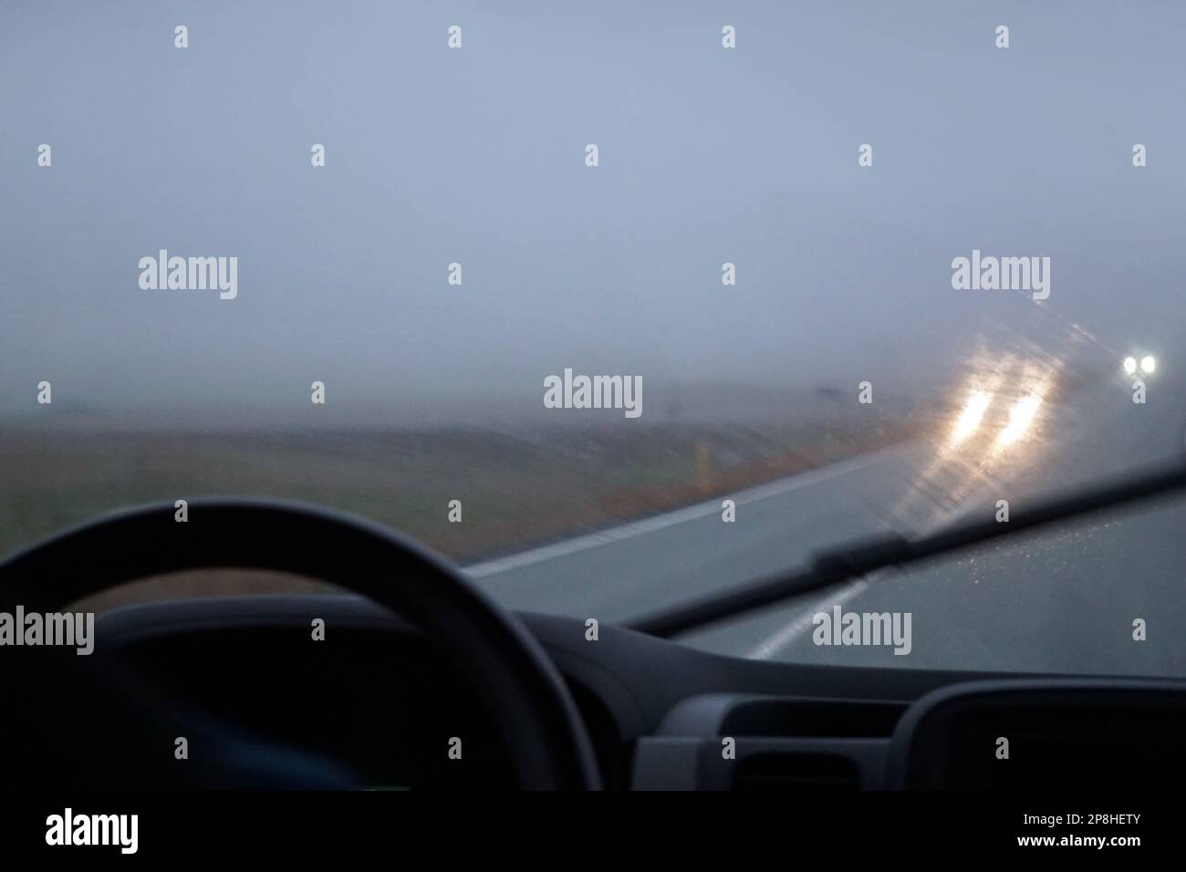 Driving a car in the rain with activated windshield wipers Stock Photo ...