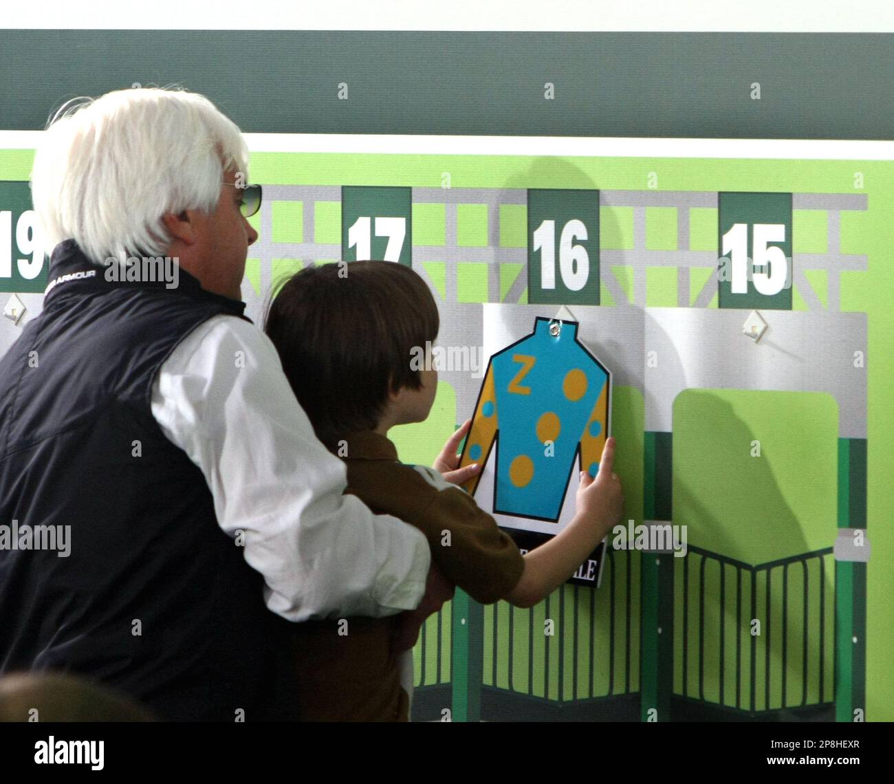 Trainer Bob Baffert, left, gives son Bode a hand in hanging the colors ...