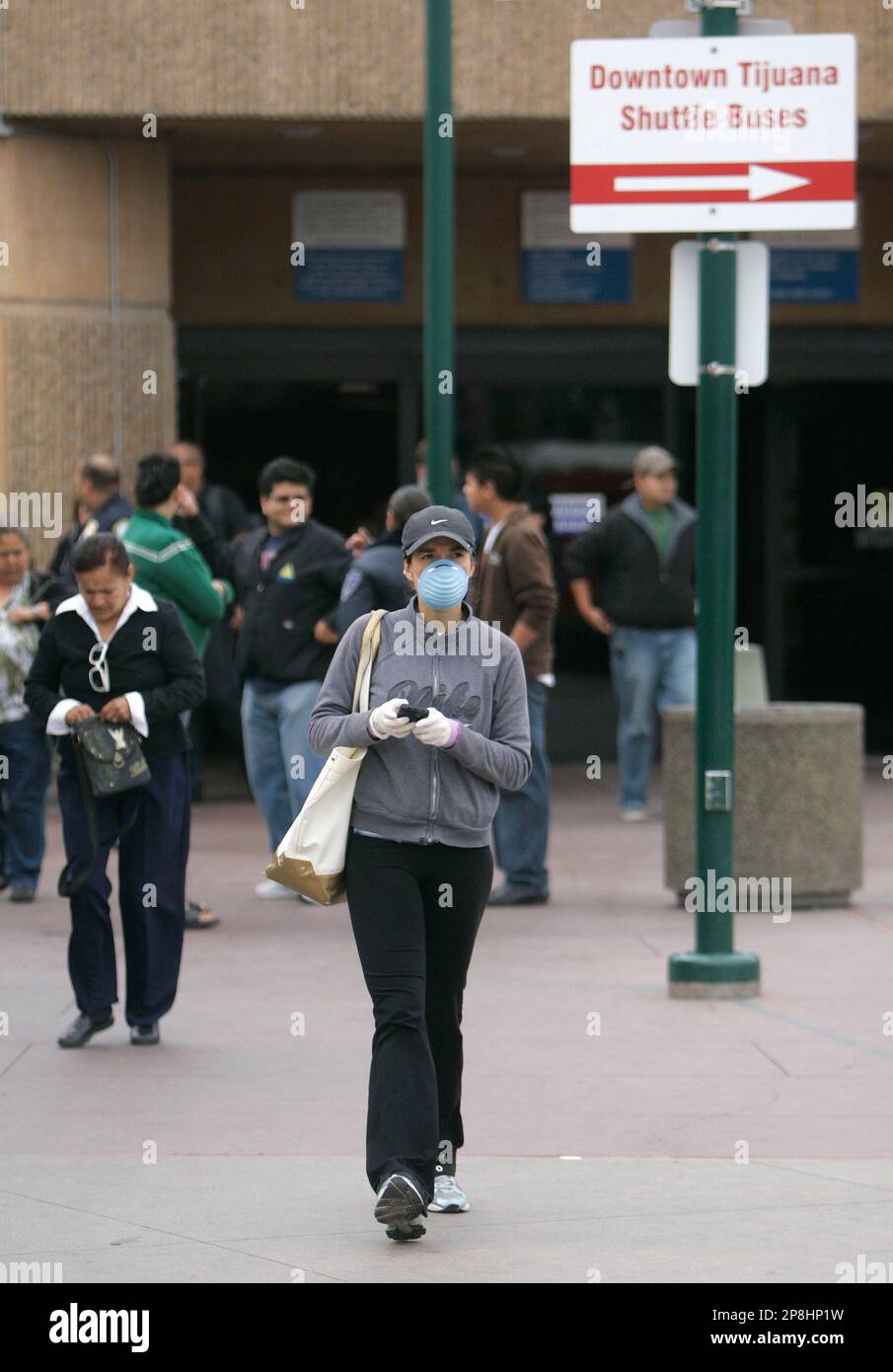 Maria Whipple, of San Diego, wears a surgical masks exiting the San ...