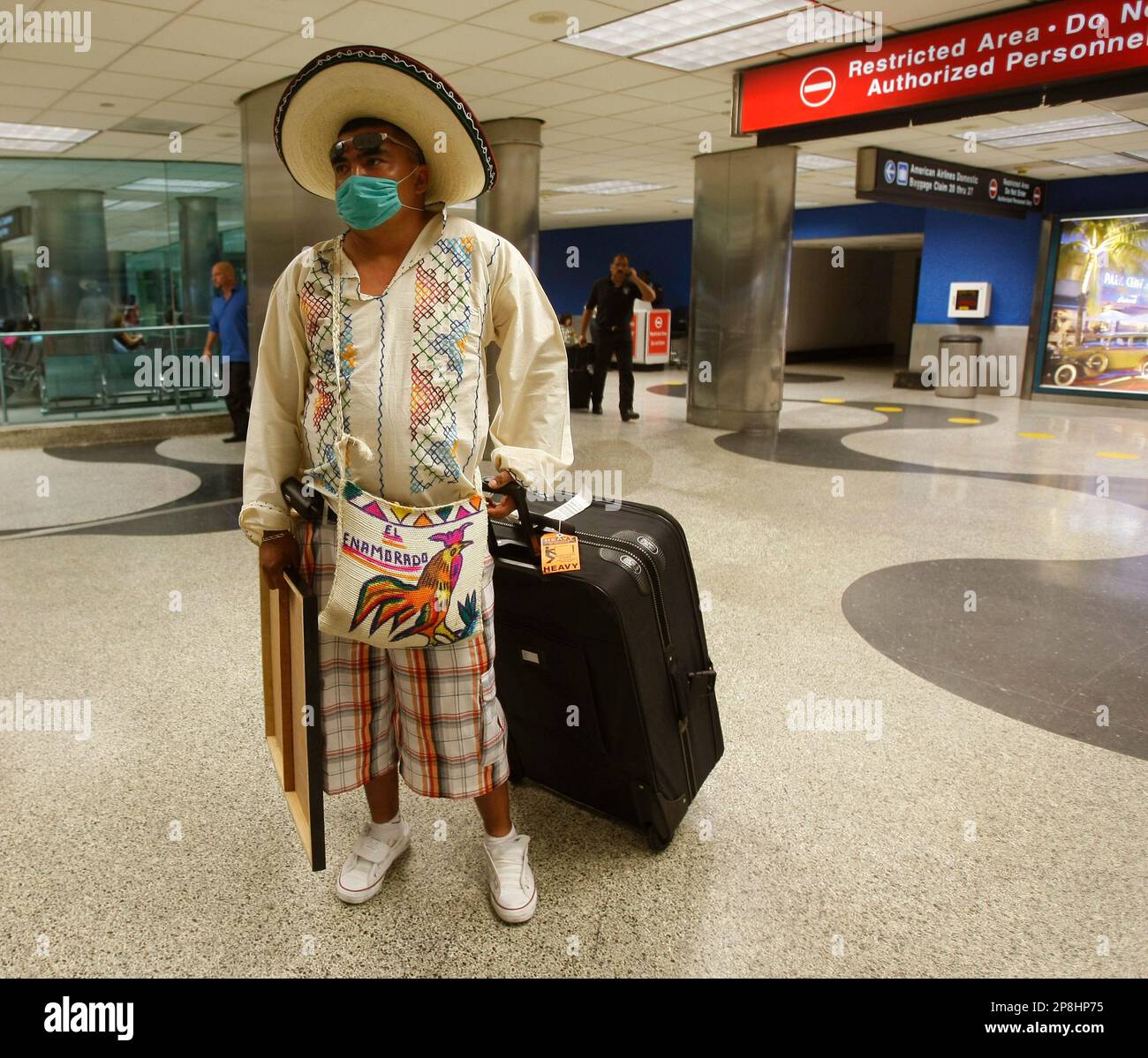 Marco Lugo walks through the Miami airport, Monday, April 27, 2009 ...