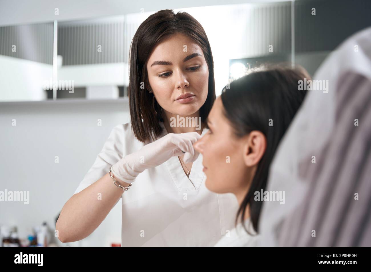 Cosmetologist doing cosmetic procedures to client, skin nutrition Stock ...