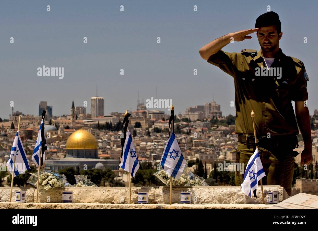 With the Dome of the Rock Mosque in the background, an Israeli soldier ...
