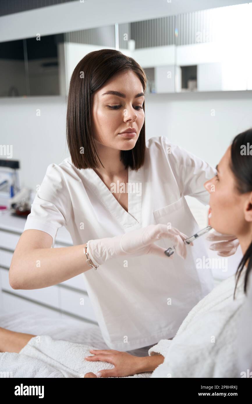 Female on injection procedure for facial skin nutrition Stock Photo - Alamy