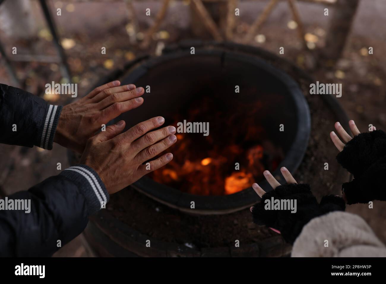 Homeless man warming hands near hi-res stock photography and images - Alamy