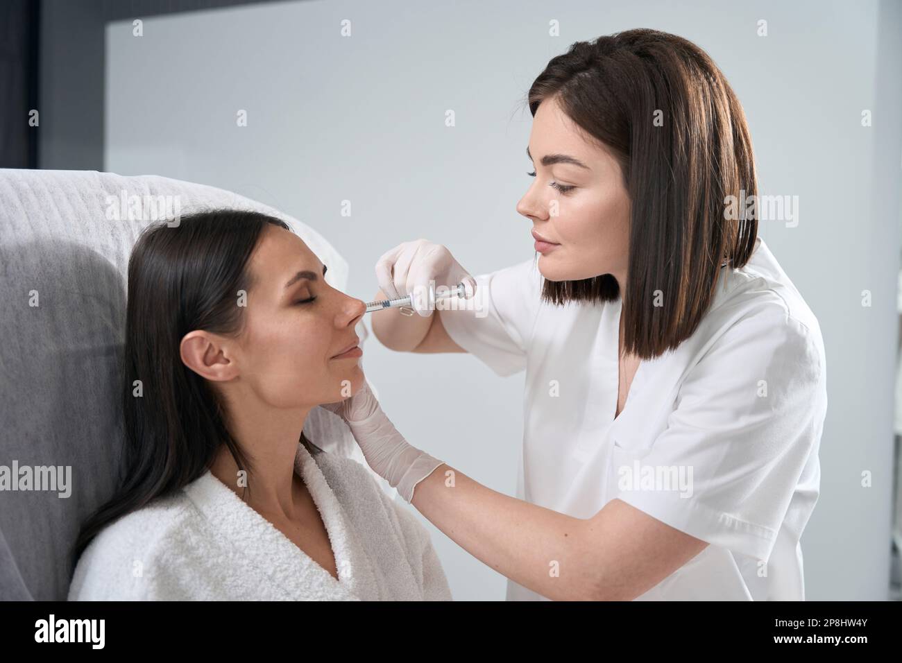 Pretty female on injection procedure for facial skin nutrition Stock ...
