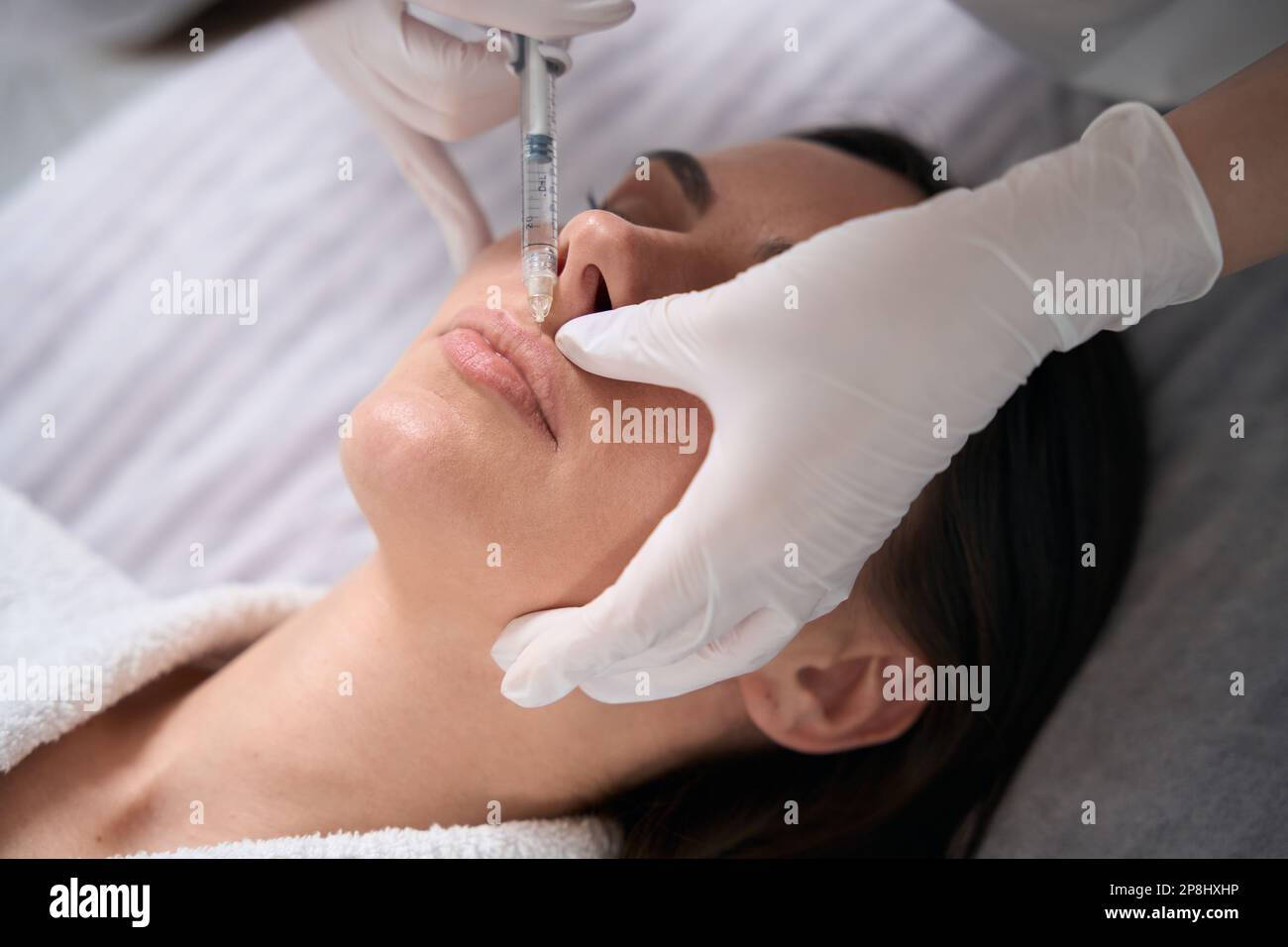 Pretty woman on injection procedure in cosmetology cabinet Stock Photo ...