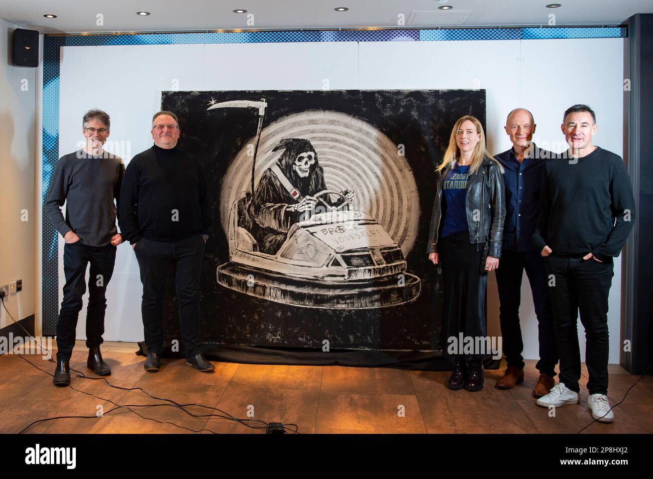 The band "Brace Yourself" pose next to the painting by the artist ...