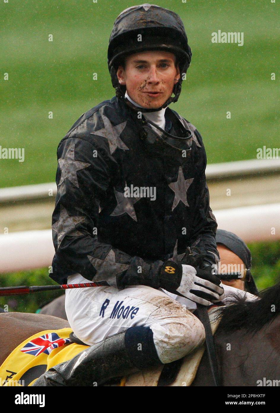 Britain's jockey Ryan Moore riding Presvis has mud on his face after ...