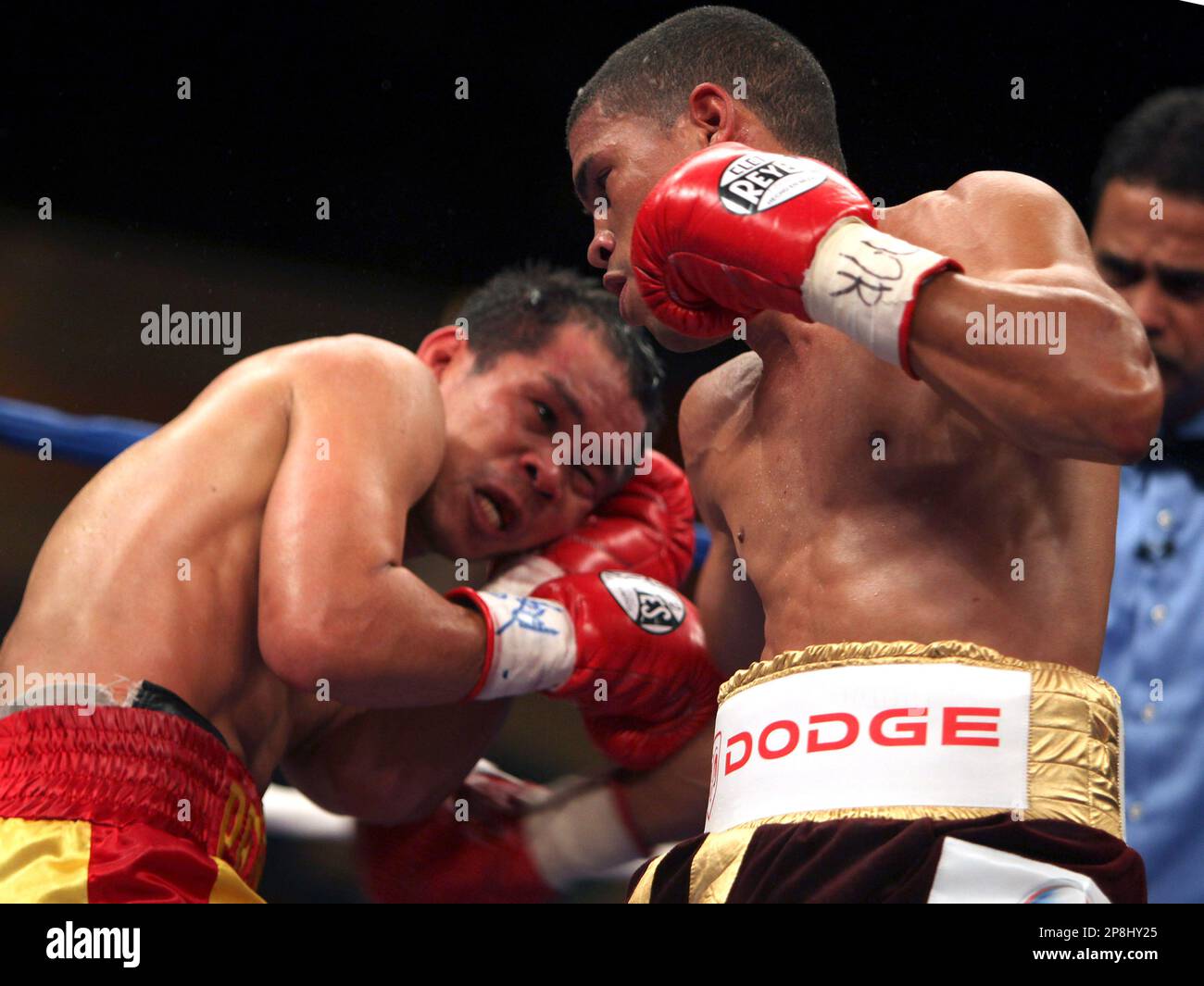 Puerto Rican boxer Juan Manuel Lopez, right, lands a blow to the ...