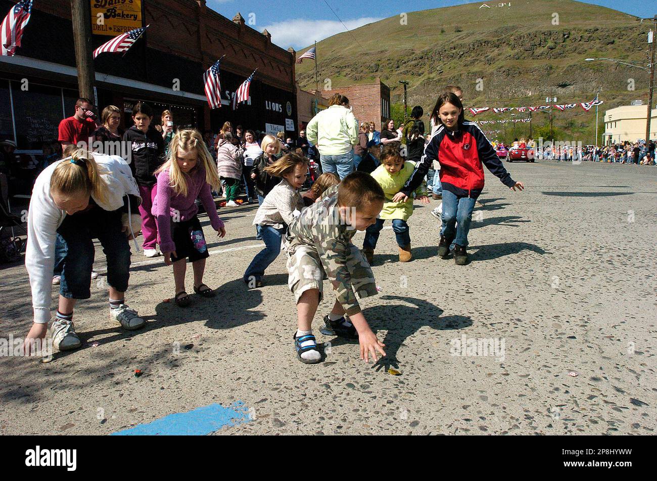 Kids scurry for their bounty of candy as the many floats and parade ...