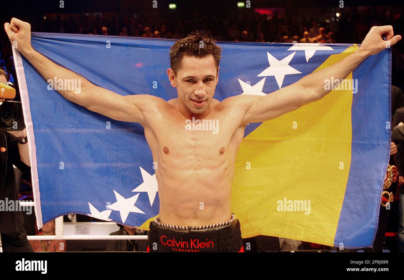 Germany's boxer Felix Sturm shows the flag of Bosnia after winning the ...