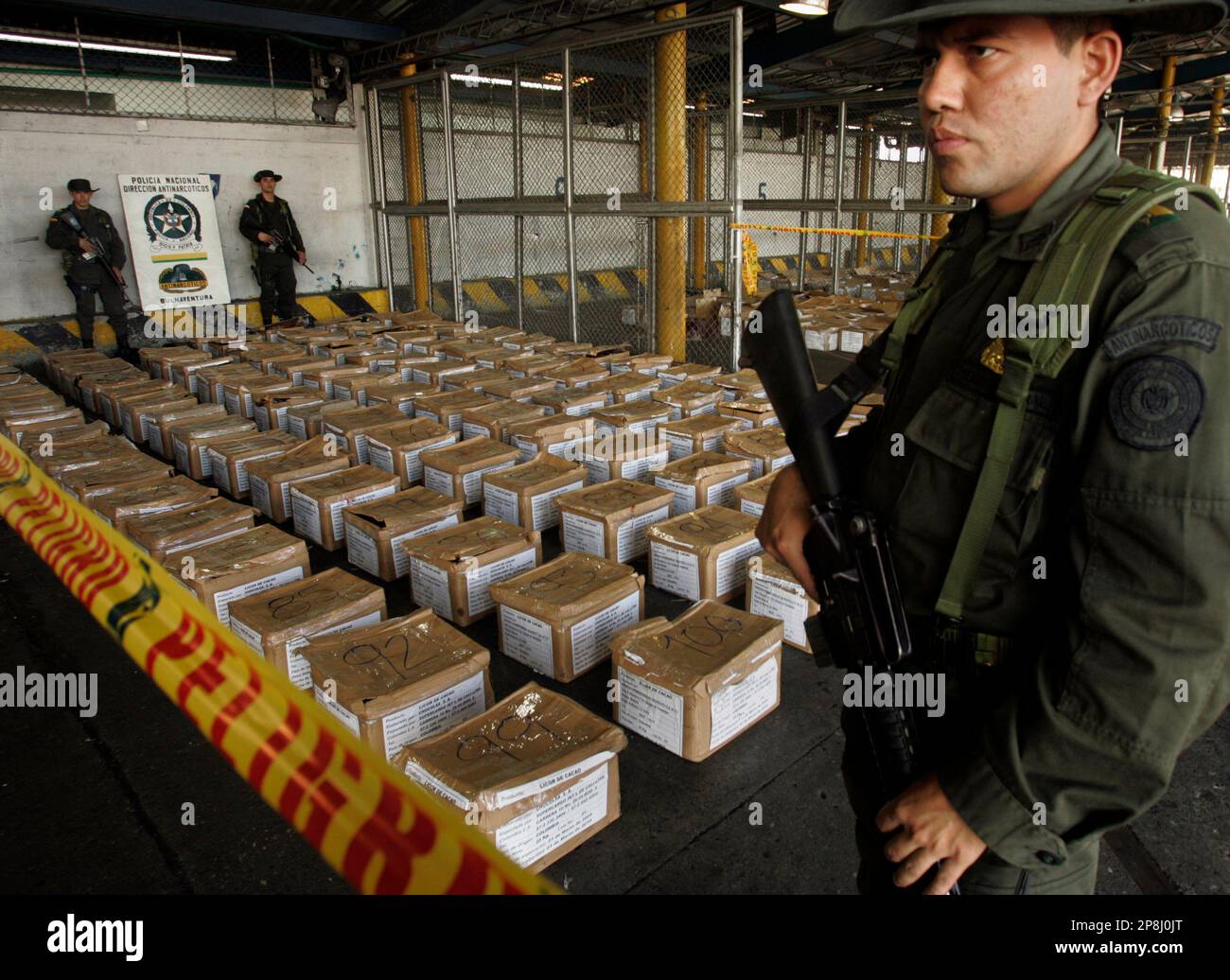 Counter narcotics police officers guard boxes containing cocaine in ...