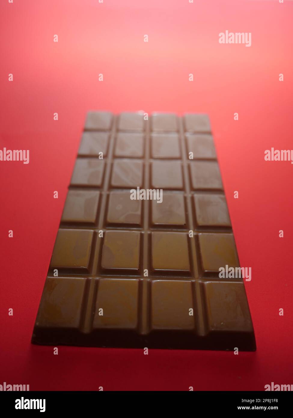 chocolate bar on a red background Stock Photo - Alamy