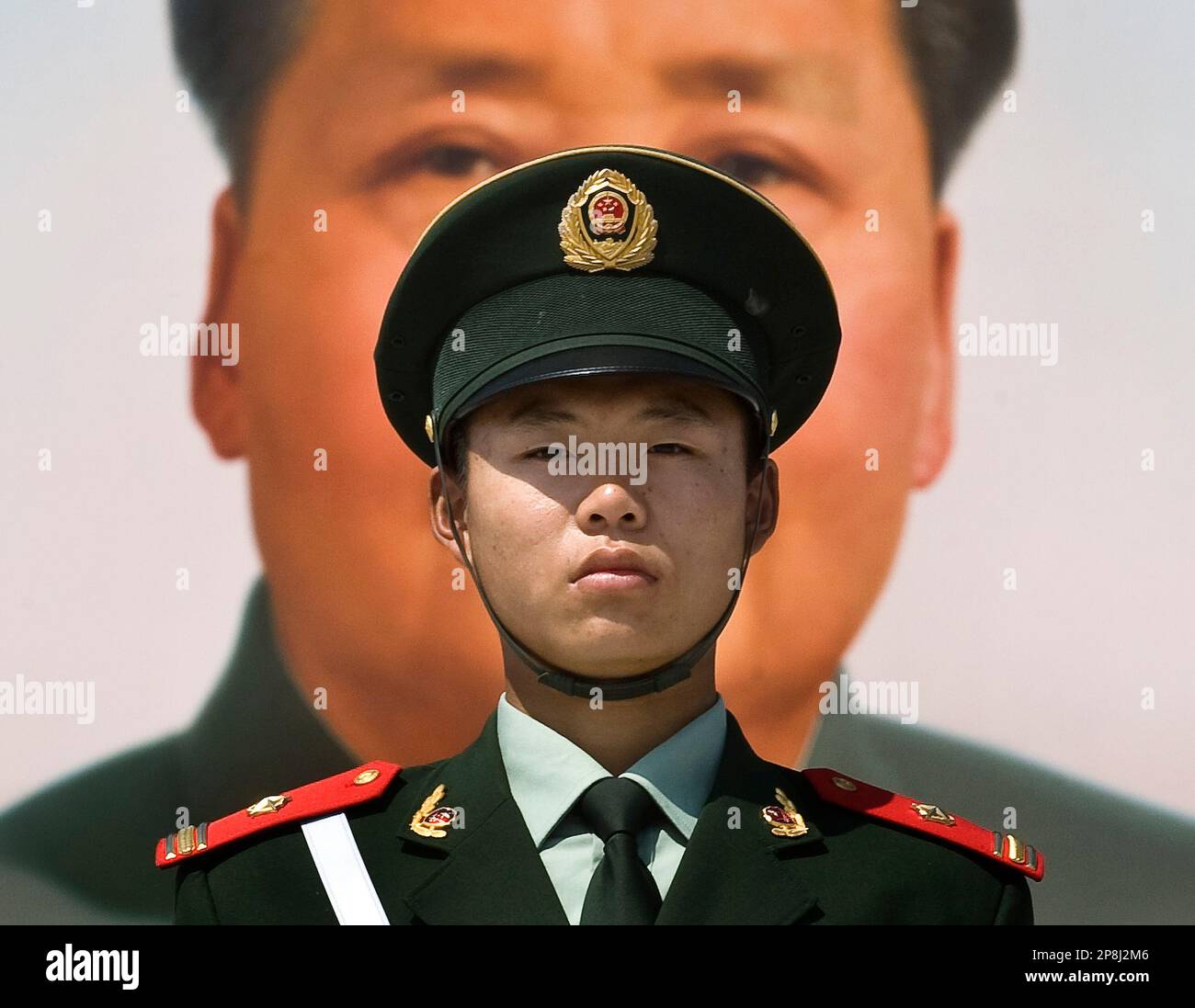 A Chinese paramilitary police officer stands guard on duty in front of ...