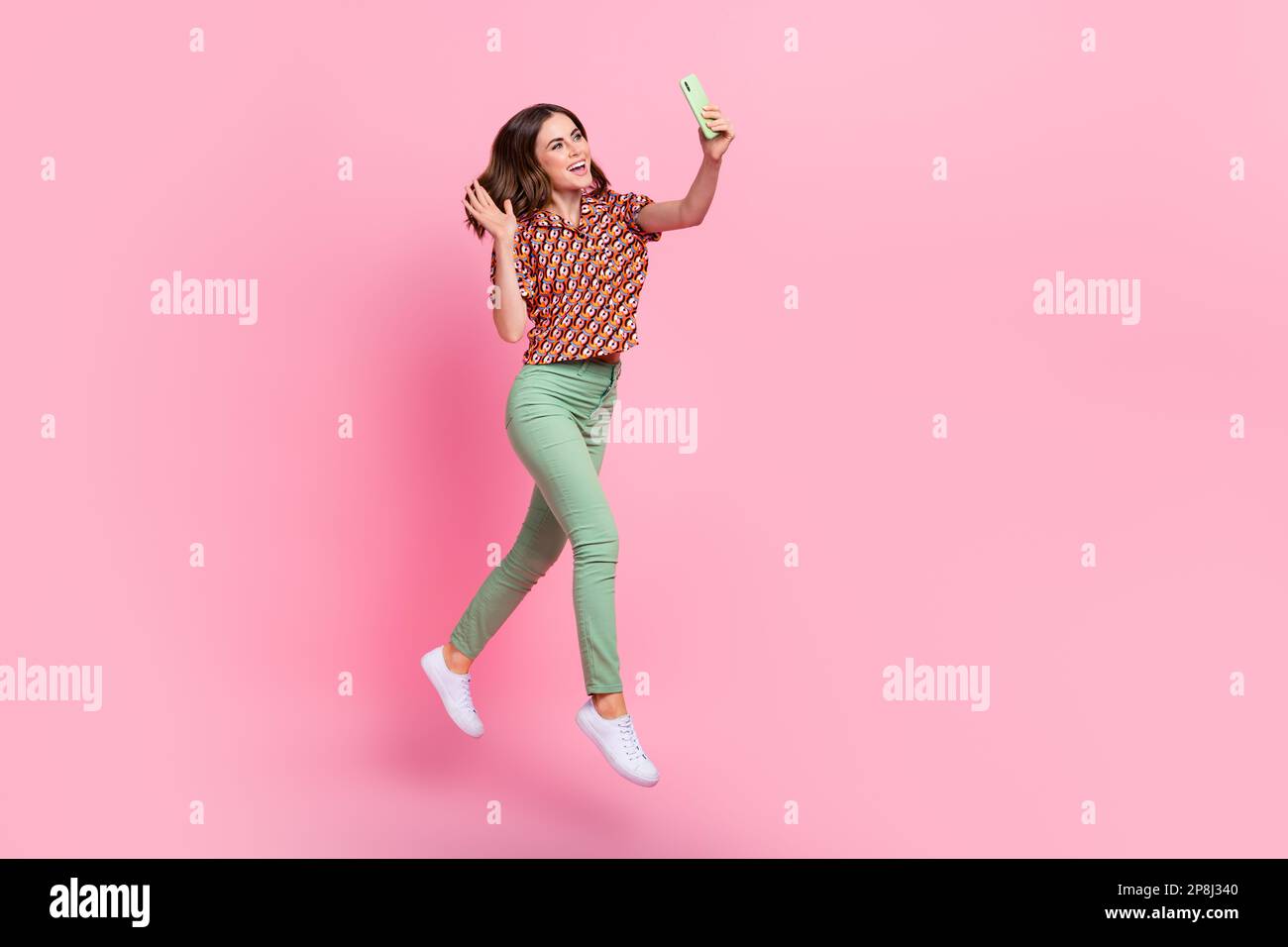 Full length portrait of excited active person jump rush hold telephone ...