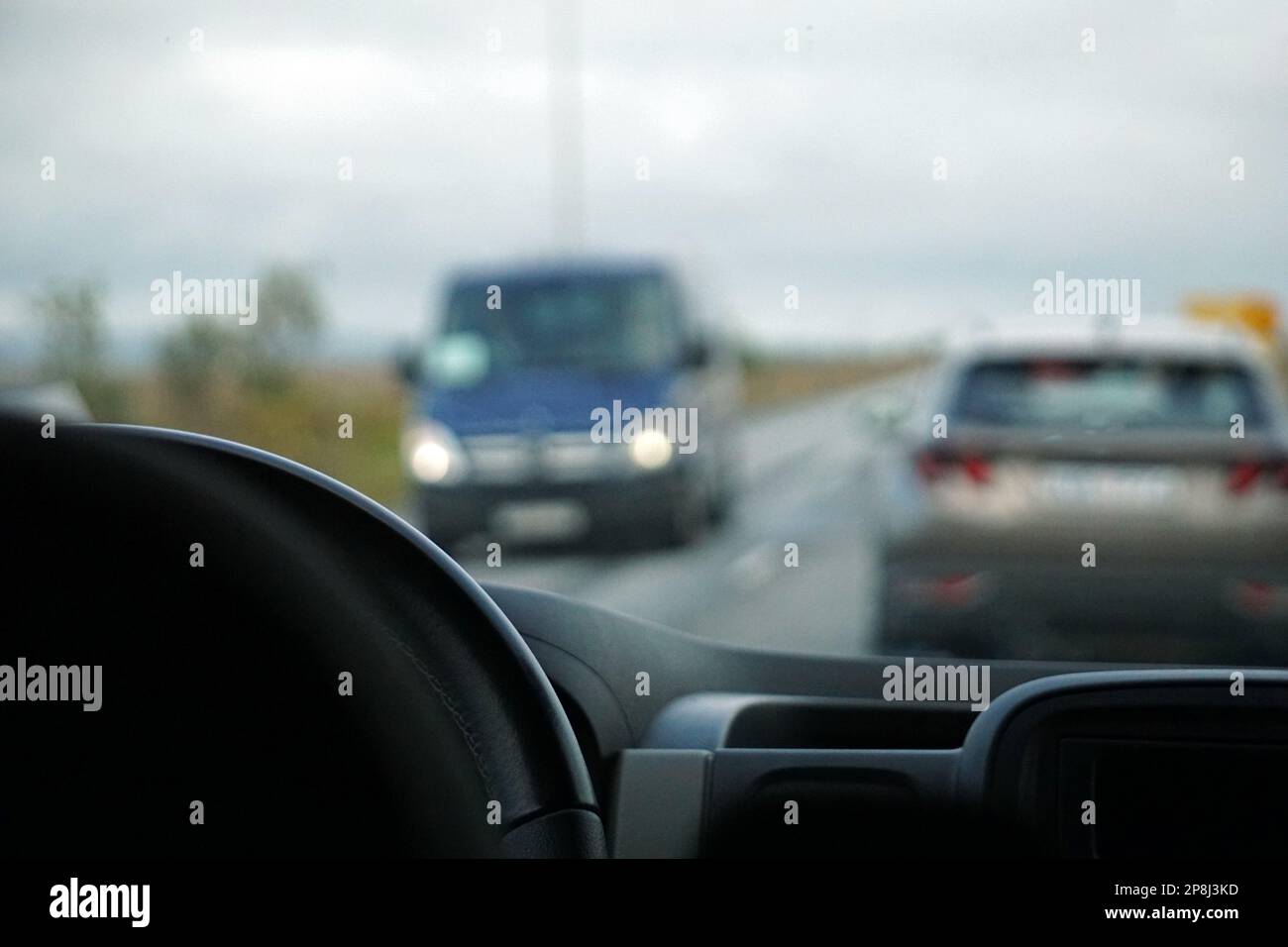 Driving a car - perspective of a driver - bokeh effect Stock Photo - Alamy