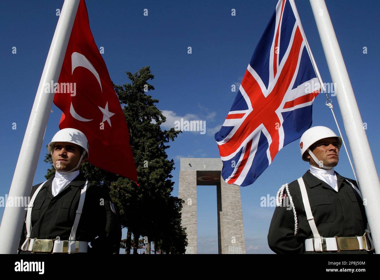 Turkish soldiers stand guard next to a Turkish flag, left, and a Union ...