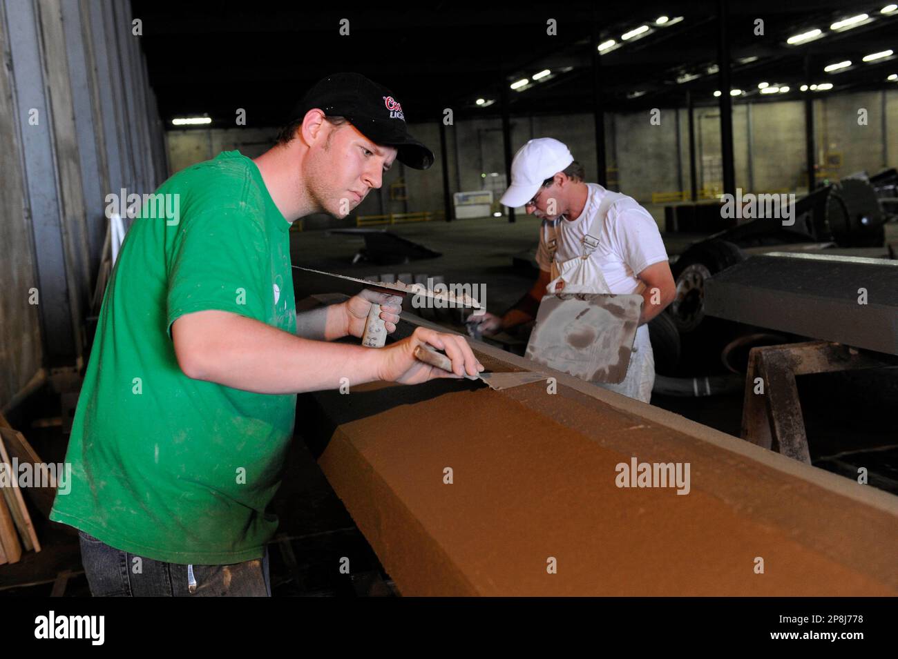 Sculptors David Whatley, left, and Douglas Oswaldo work on the set of ...
