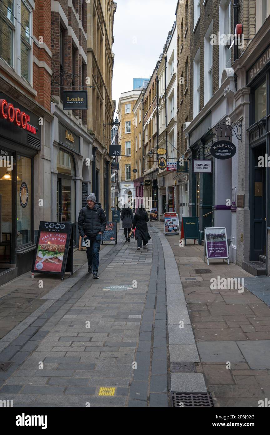 View along Bow Lane, a narrow cobbled street in the City of London ...