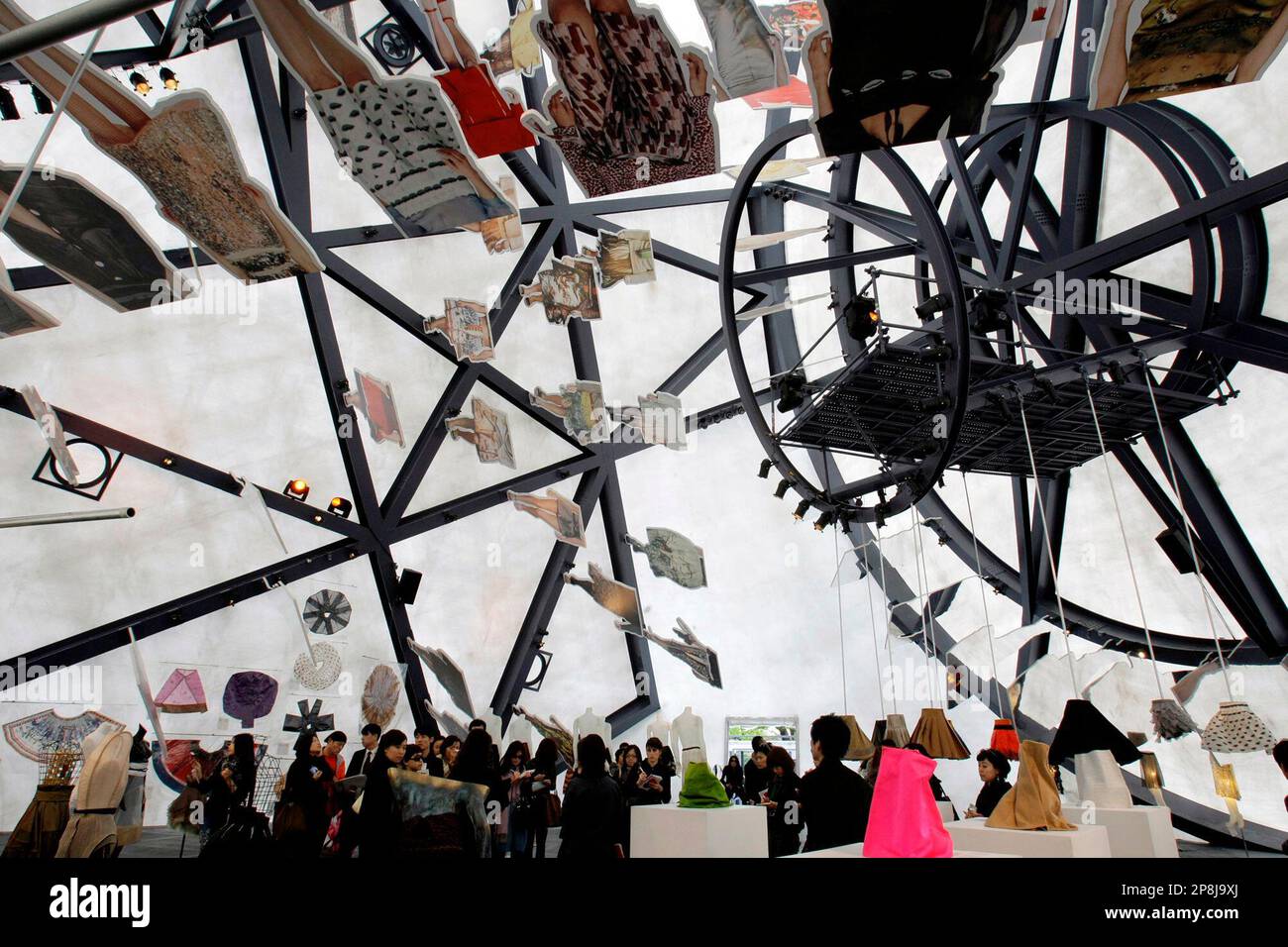 Visitors look on clothes and pictures inside of a project structure ...