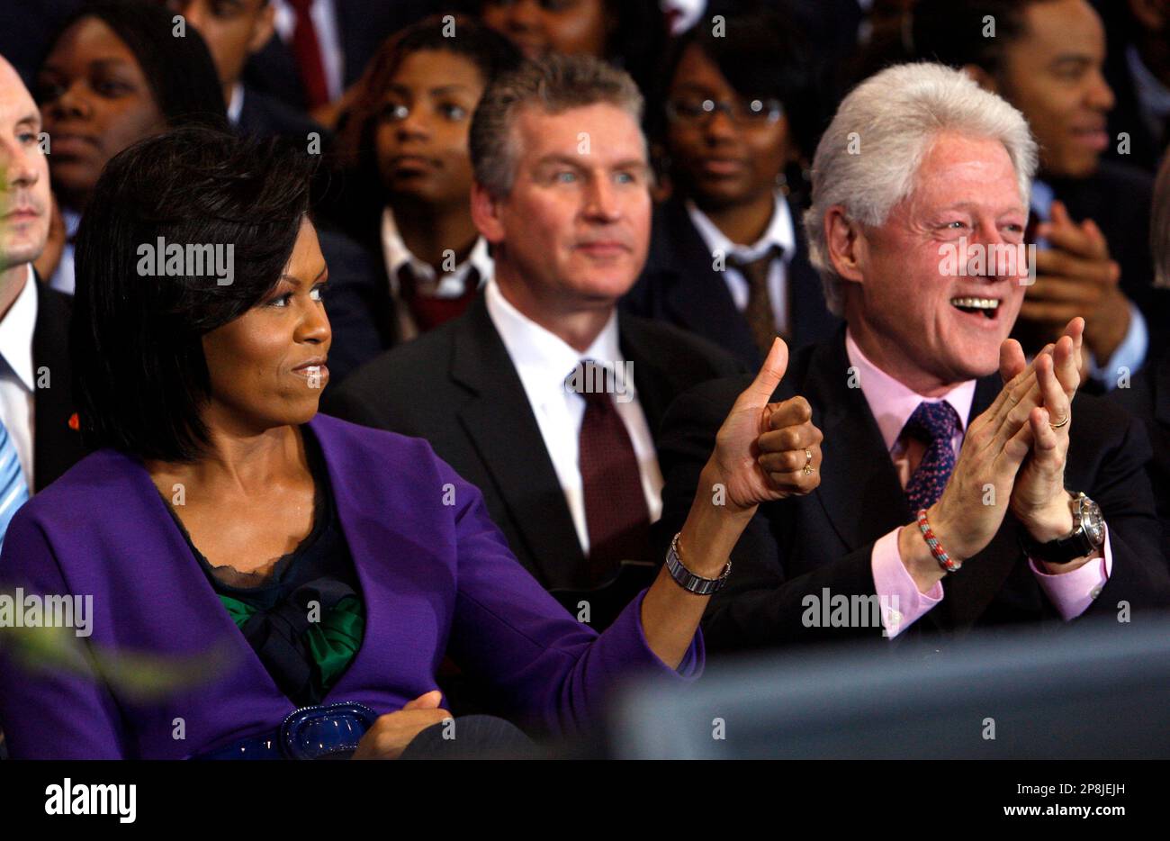 First lady Michelle Obama is seated with former President Bill Clinton ...